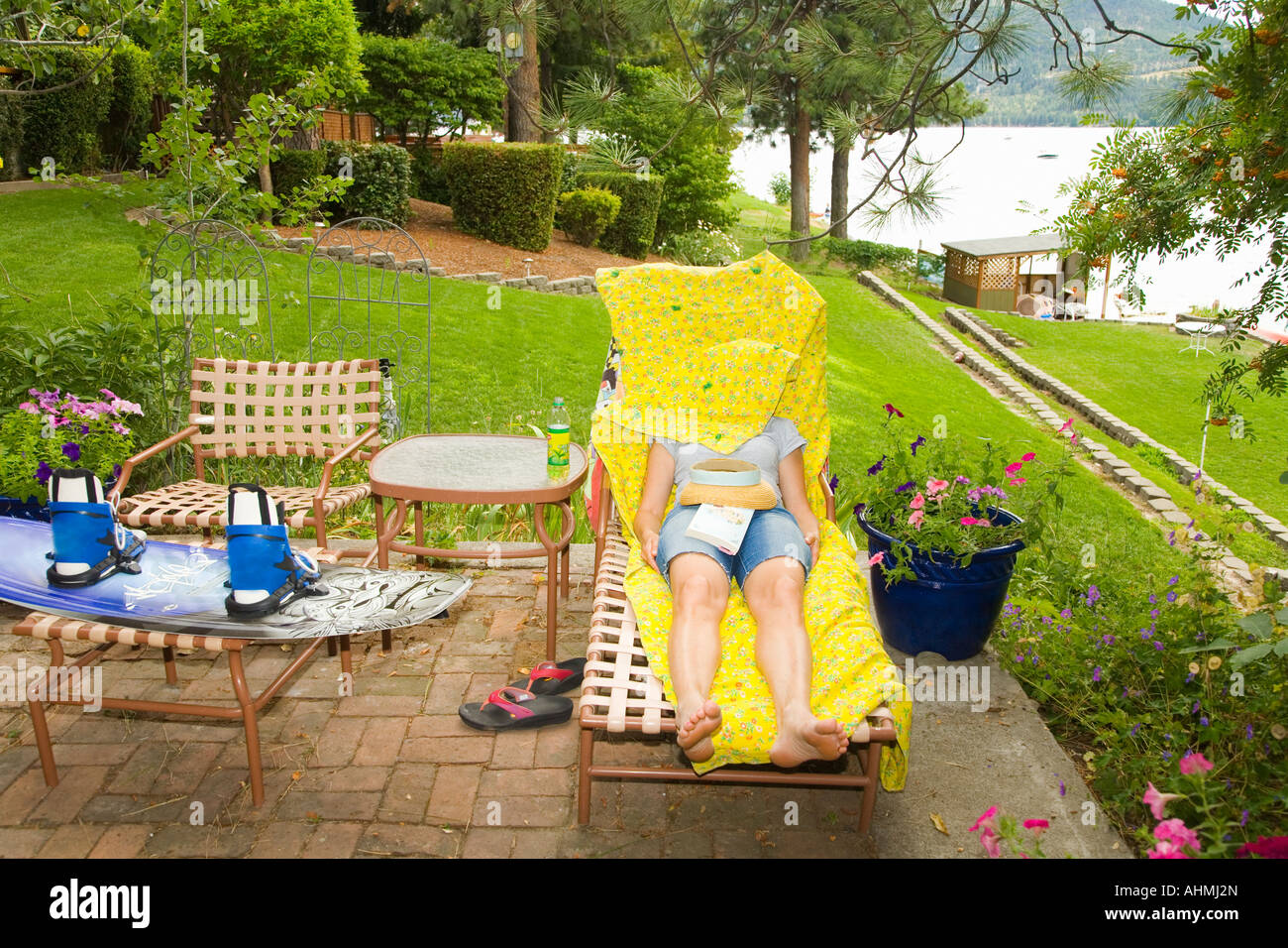 Woman in lounge chair with blanket over face Stock Photo - Alamy