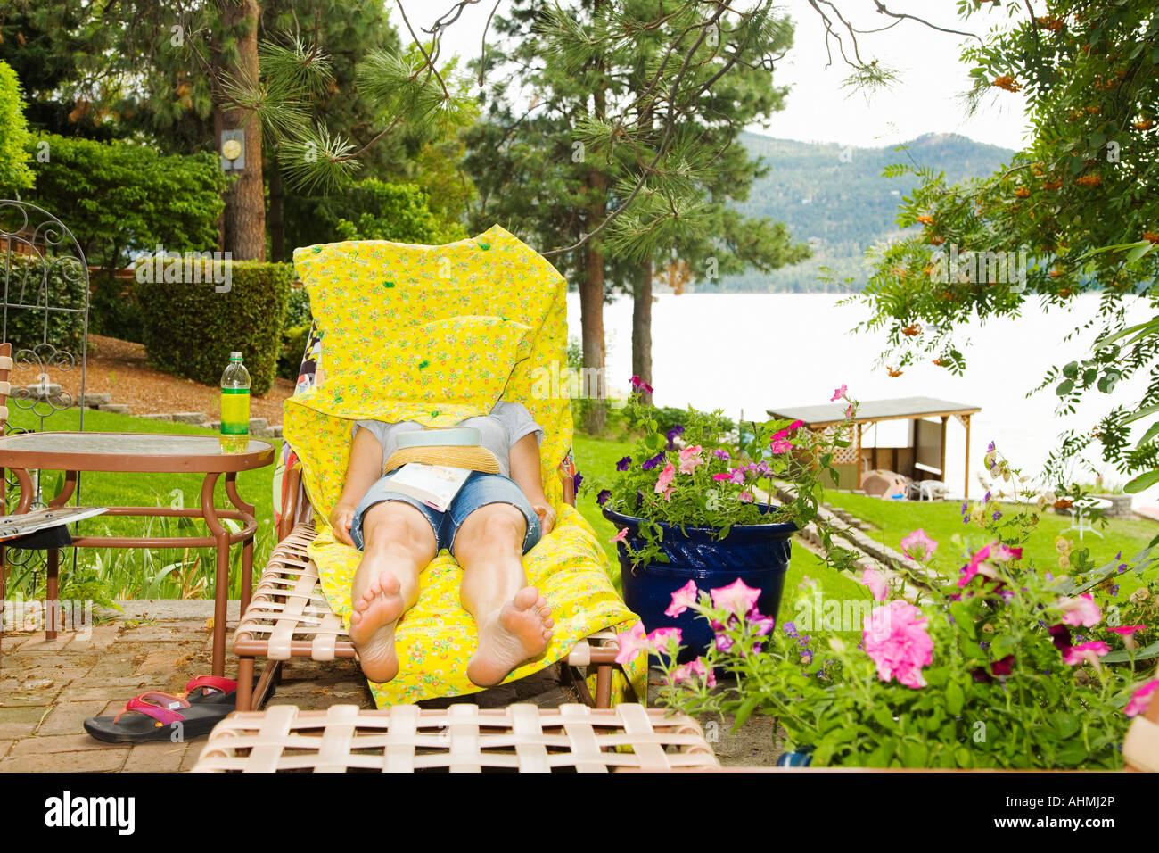 Woman in lounge chair with blanket over face Stock Photo - Alamy
