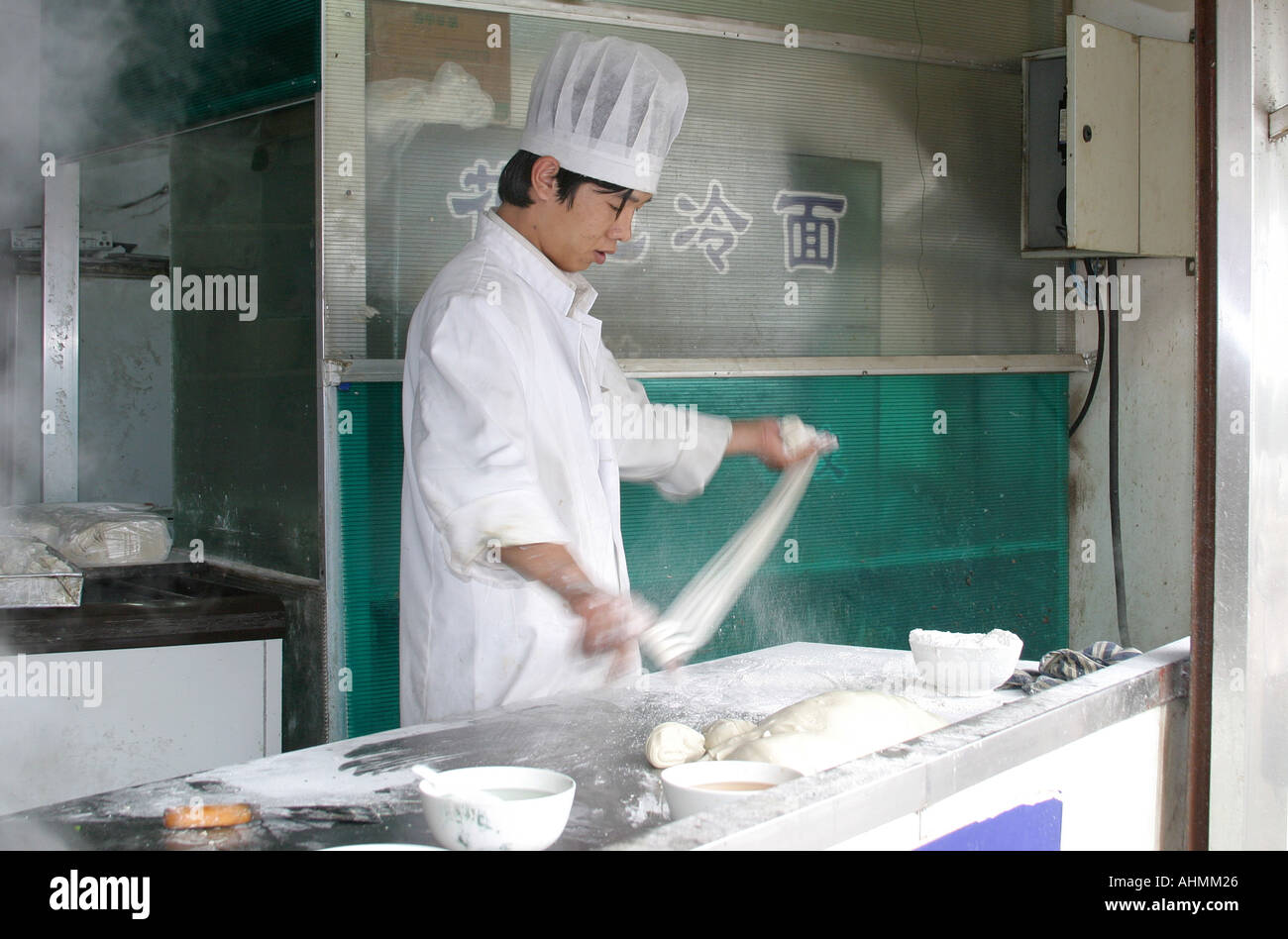 Chinese chef making noodles in a street food stall in Shanghai Stock ...