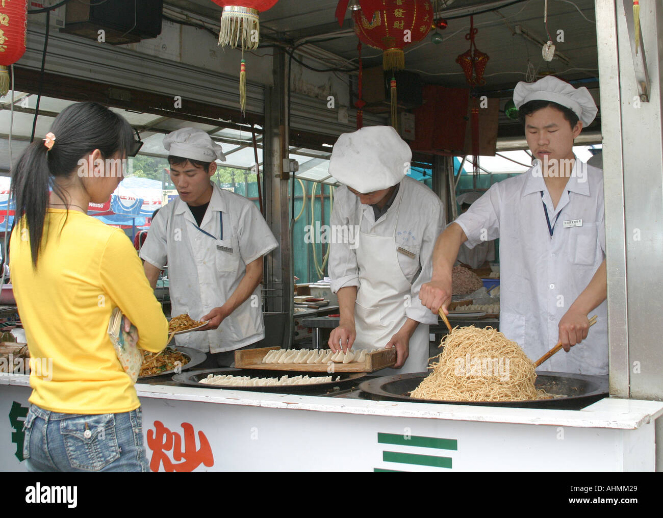 Young woman at a street noodle food stall in Shanghai Stock Photo - Alamy