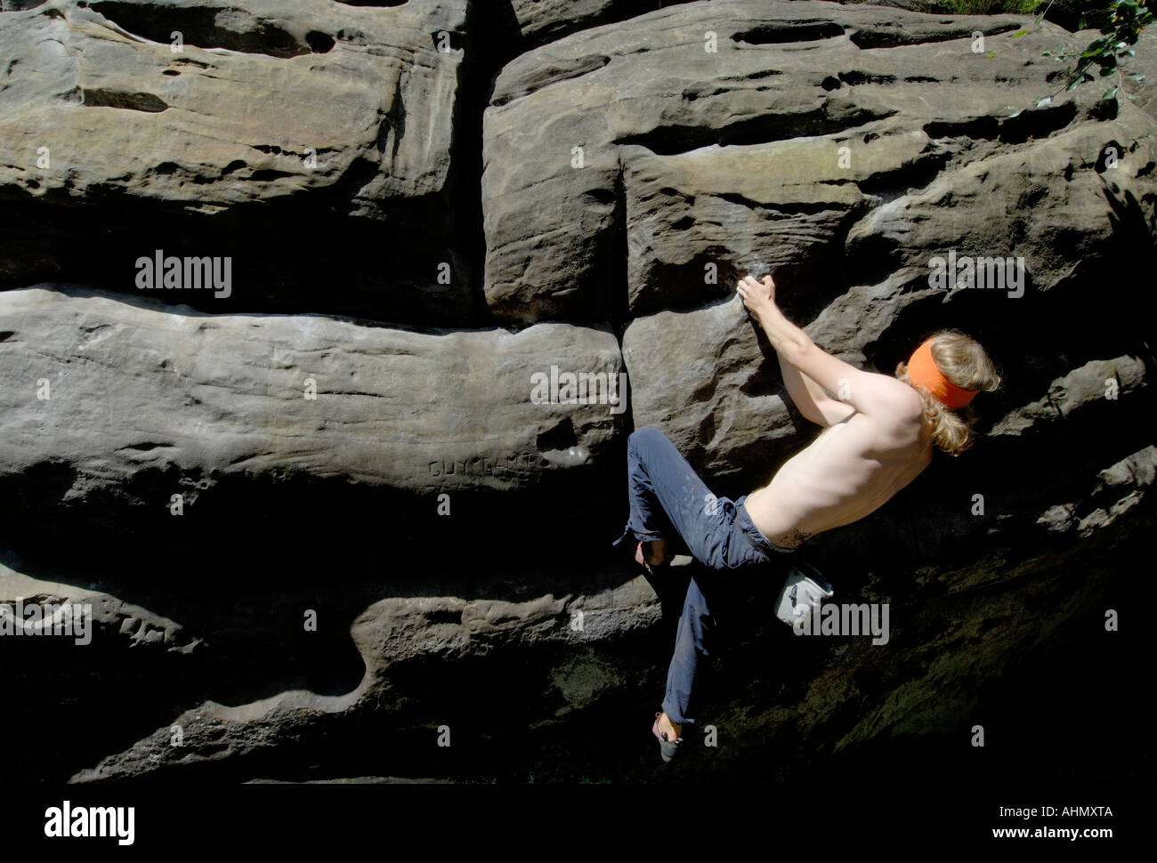 Climber at Harrisons Rocks straining at a problem Tunbridge Wells Kent ...
