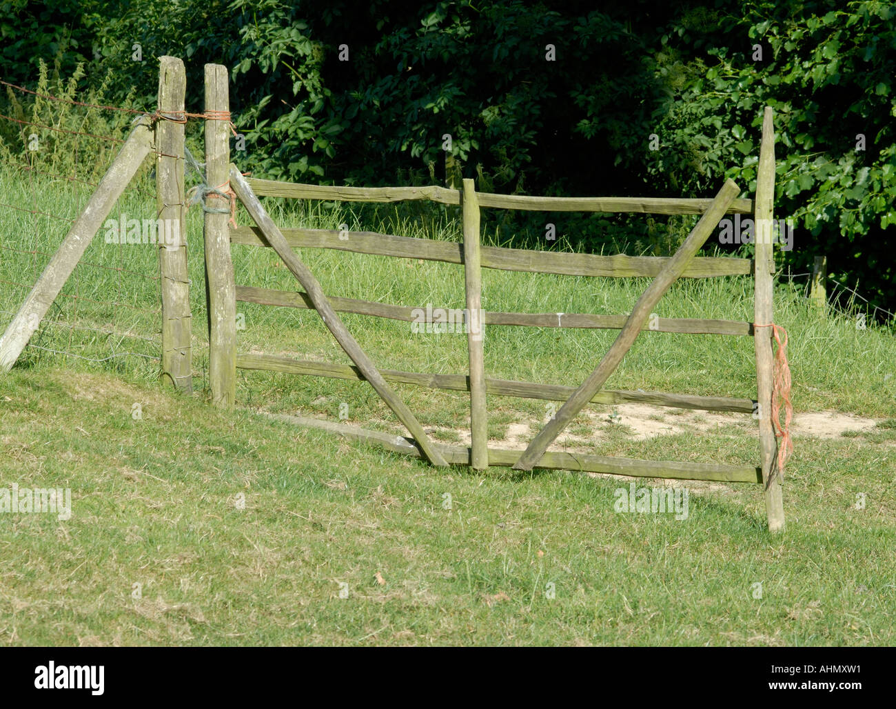 A wooden hurdle made from cloven chestnut wood is used as a gate ...