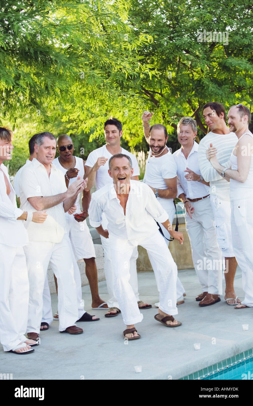 Men dancing by swimming pool Stock Photo - Alamy