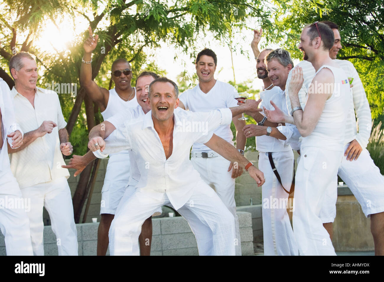 Men dancing by swimming pool Stock Photo - Alamy