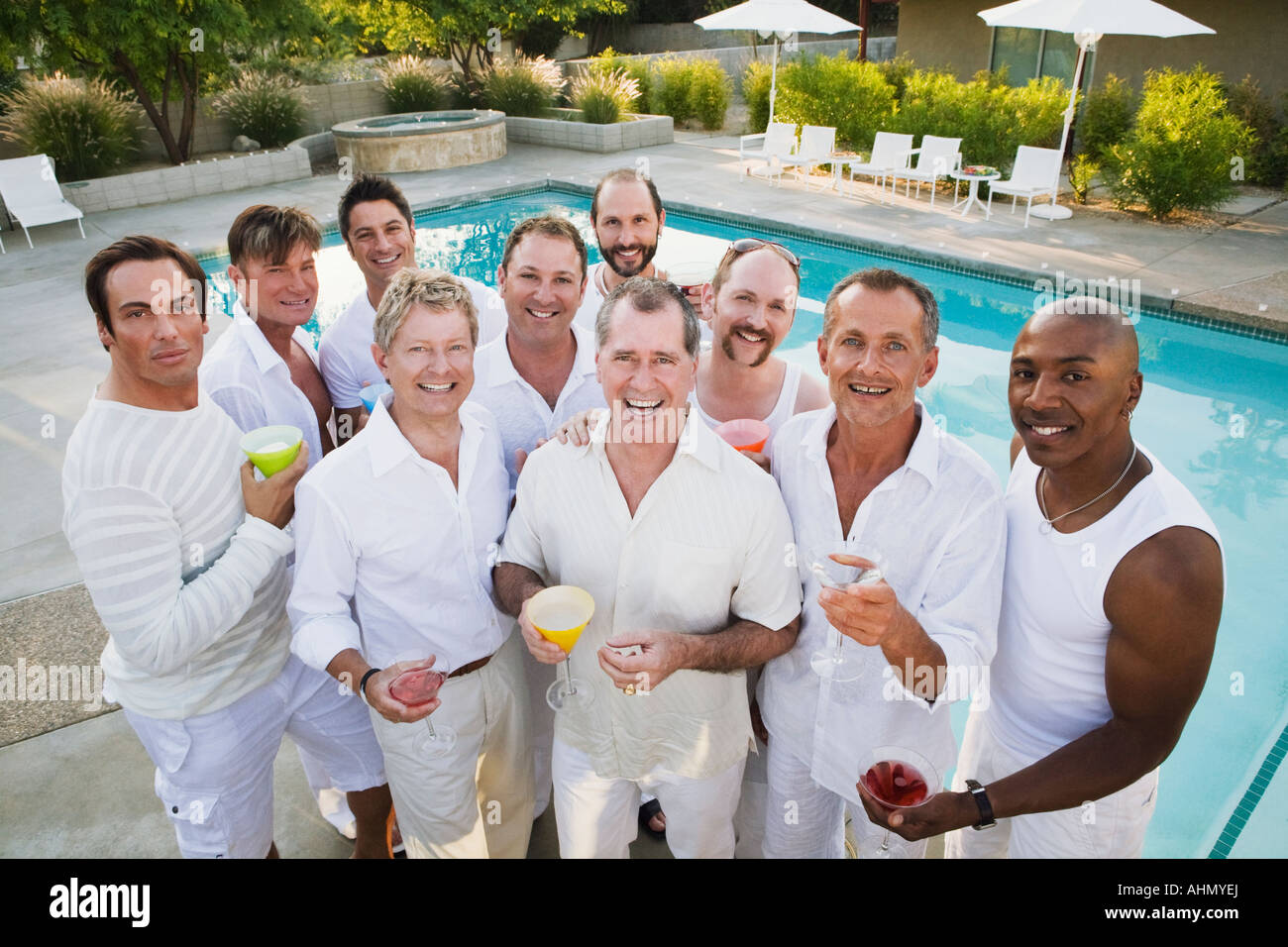 Men standing by swimming pool Stock Photo - Alamy