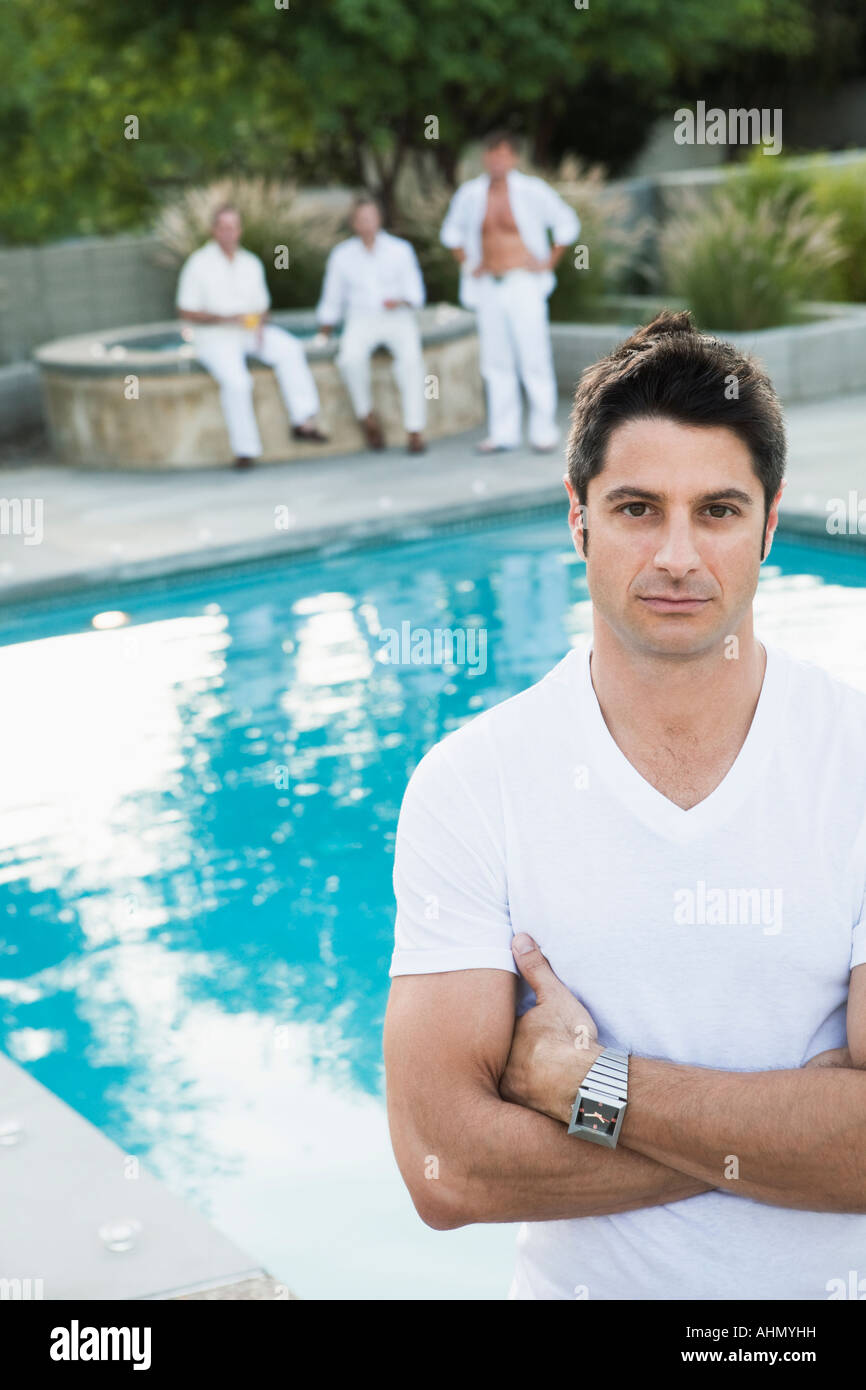 Man standing by swimming pool Stock Photo - Alamy