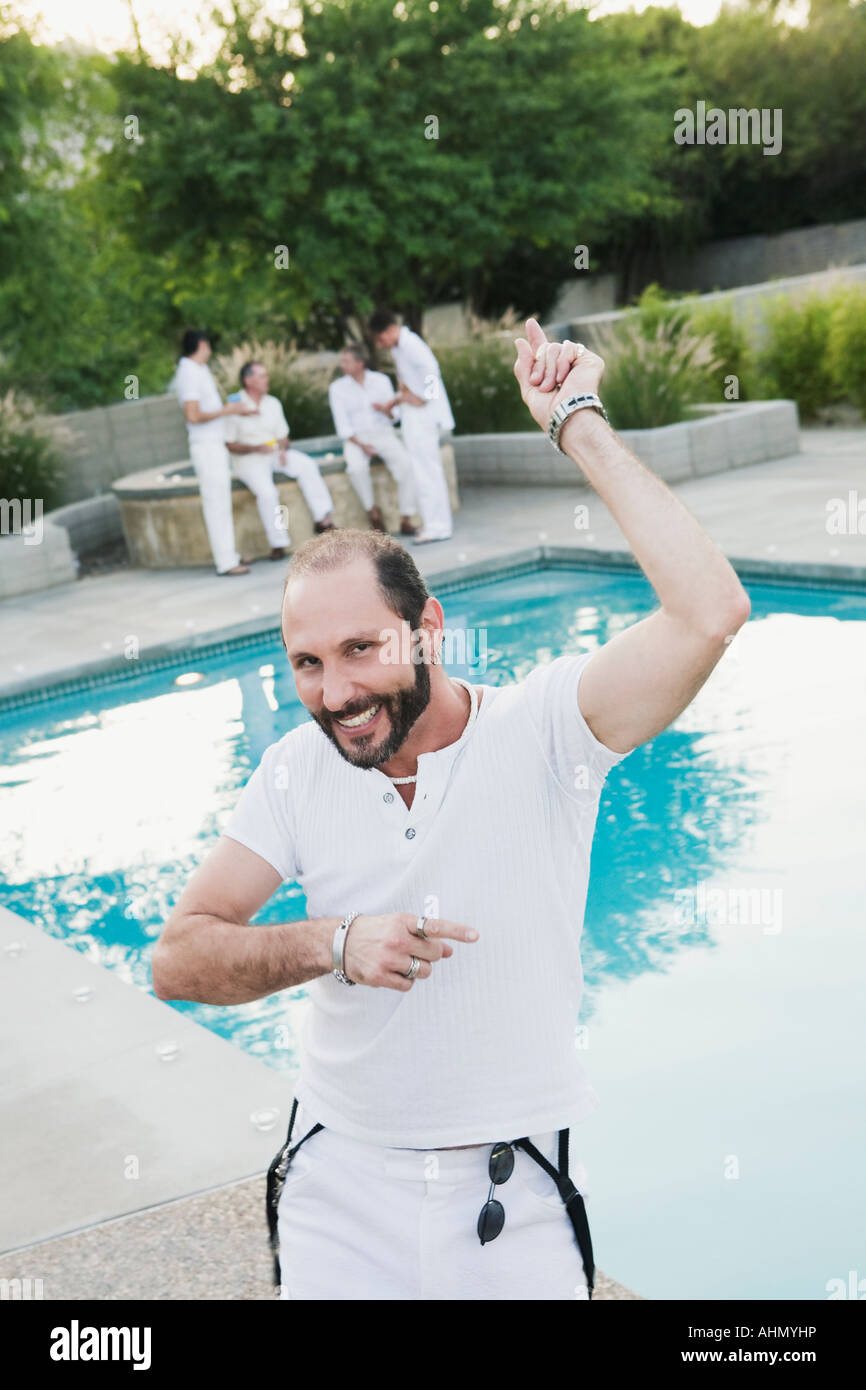 Man dancing by swimming pool Stock Photo - Alamy