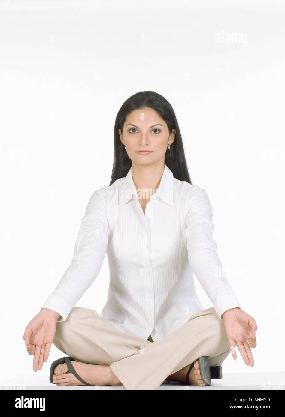 Portrait of a young woman sitting in the lotus position Stock Photo - Alamy