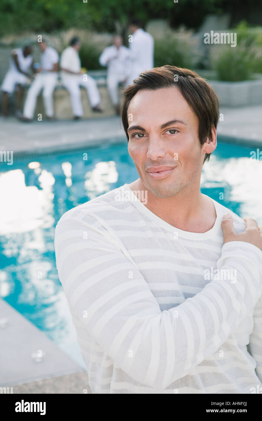 Man standing by swimming pool Stock Photo - Alamy