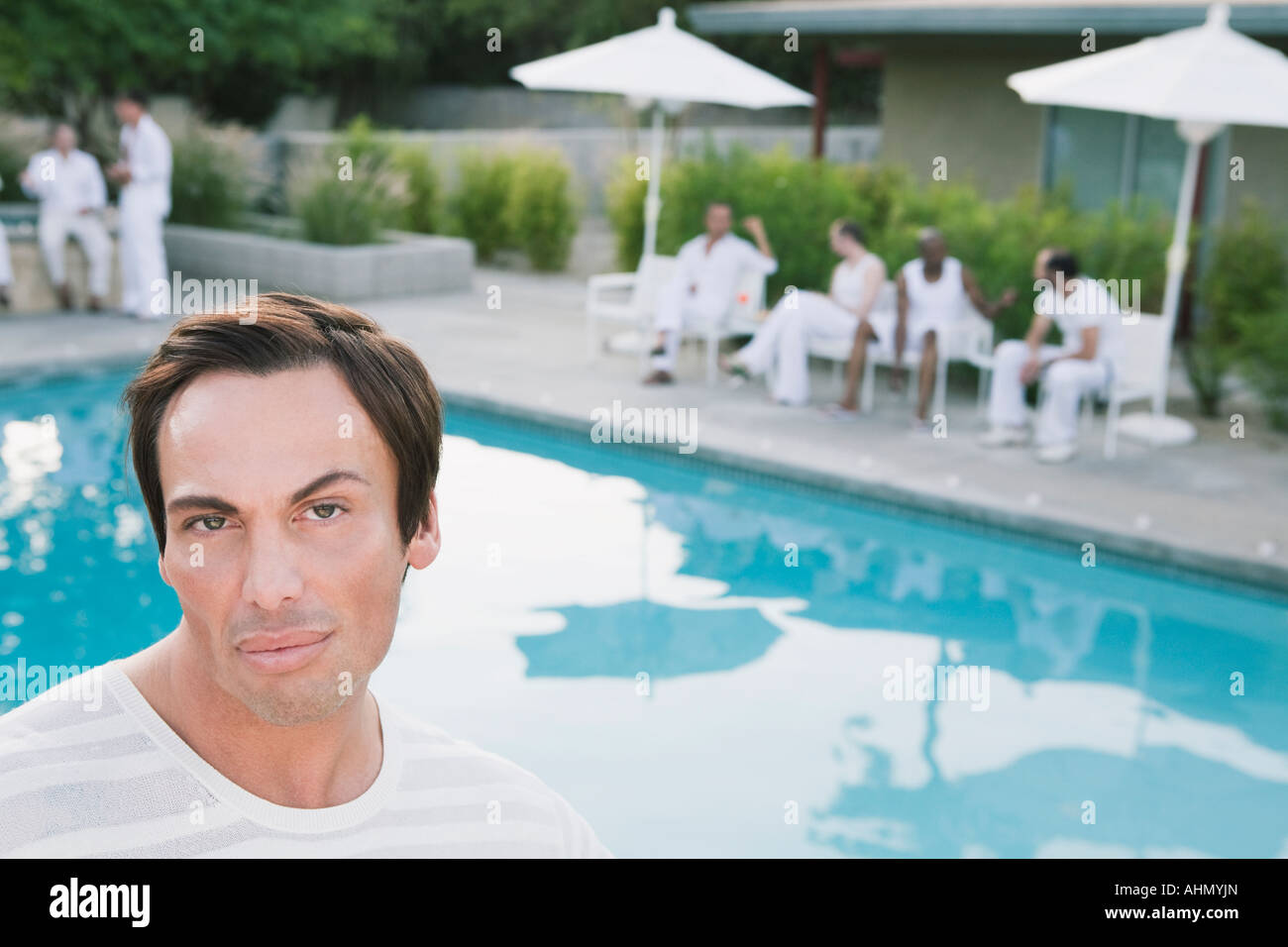 Man standing by swimming pool Stock Photo - Alamy