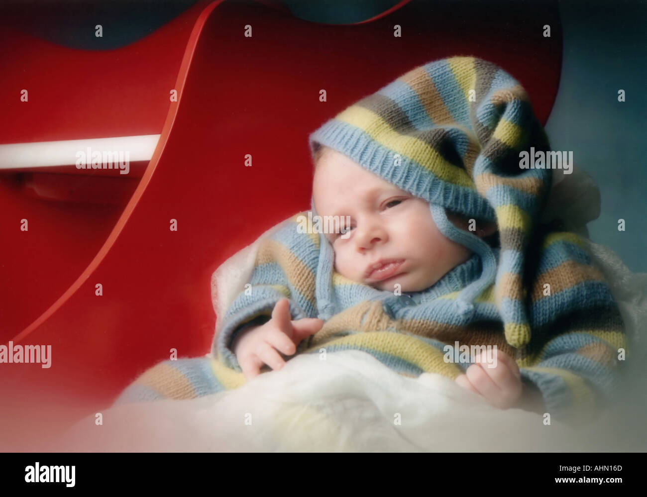 baby leaning on sleigh Stock Photo - Alamy