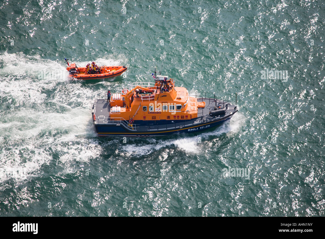 Aerial view of two RNLI Lifeboats in action. Traveling at speed in the ...
