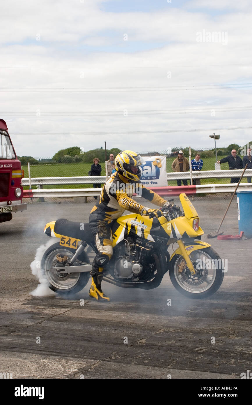 Motorbike doing a burnout prior to drag race Stock Photo - Alamy