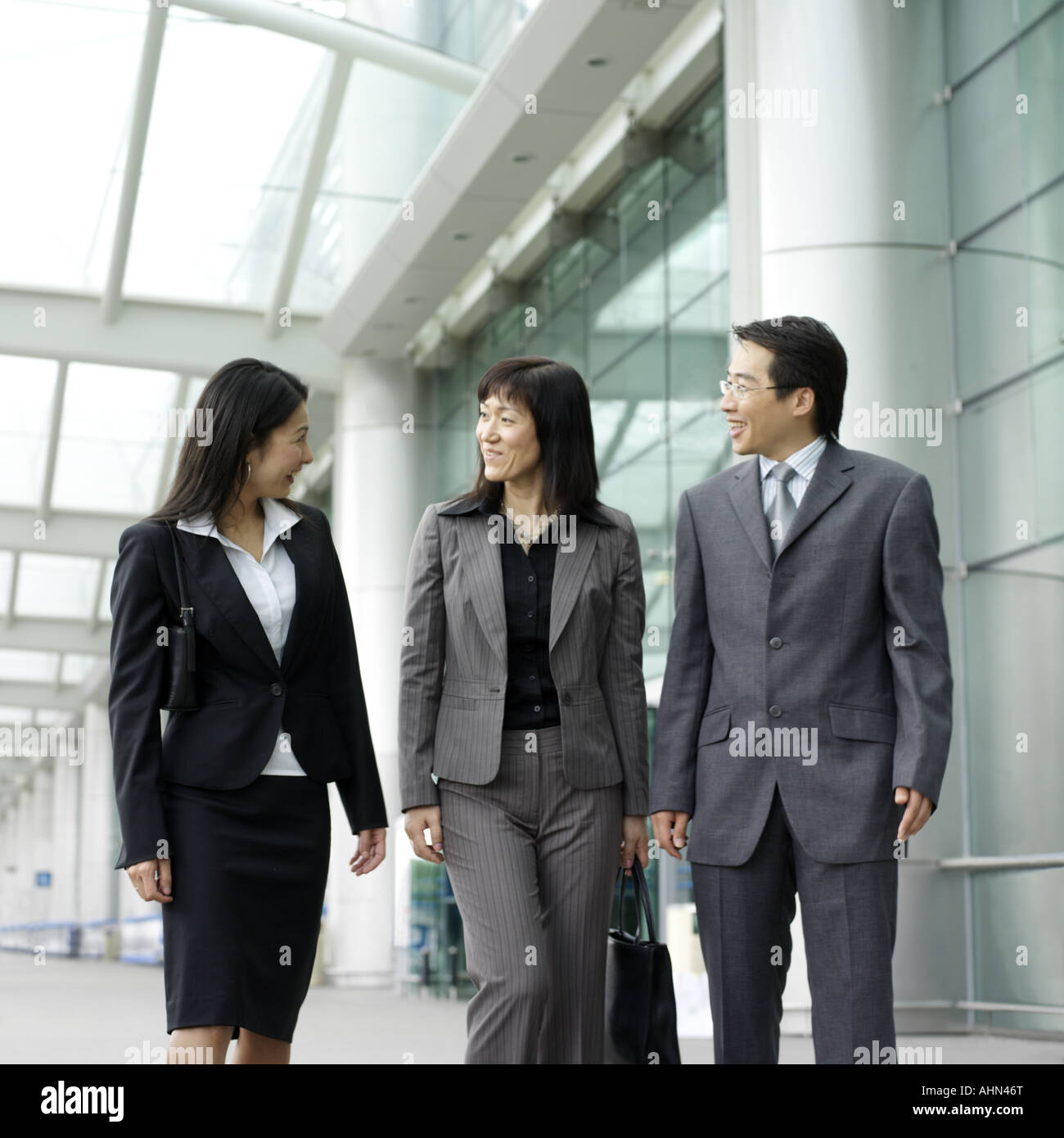 Business people walking and talking Stock Photo - Alamy