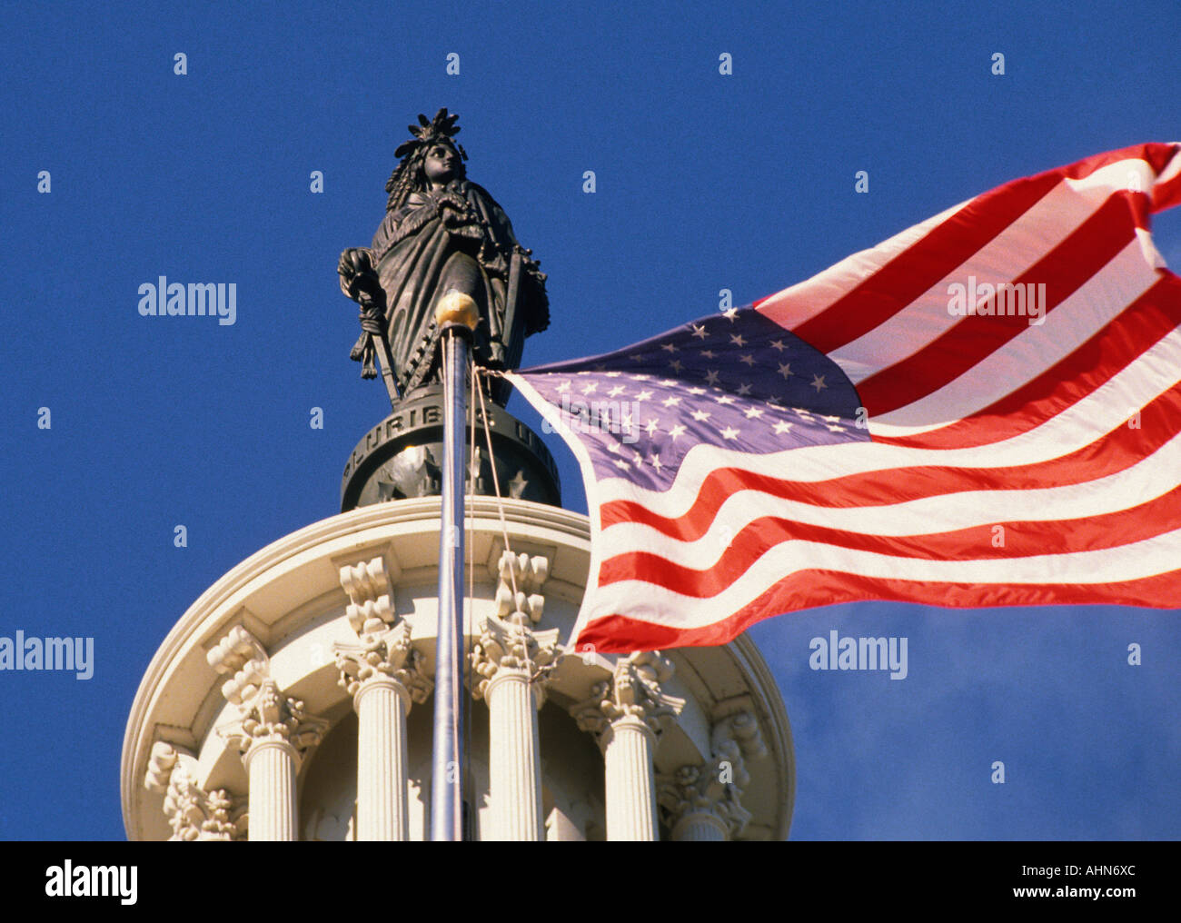 Washington DC, Capitol Building, Statue of Freedom. American flag close ...
