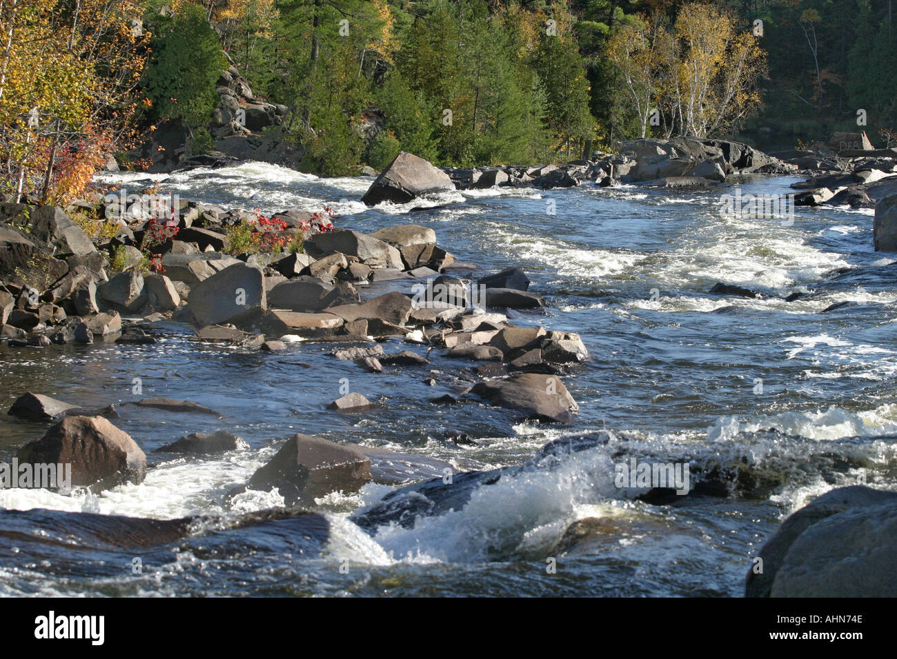 river flowing past rocks and boulders Stock Photo - Alamy