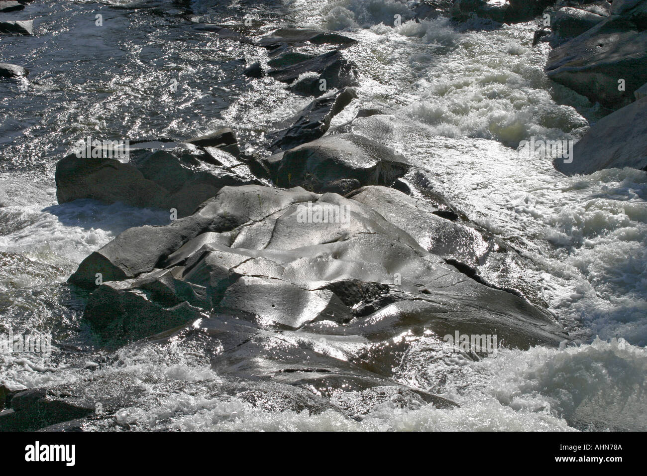 river rapids flowing past rock Stock Photo - Alamy
