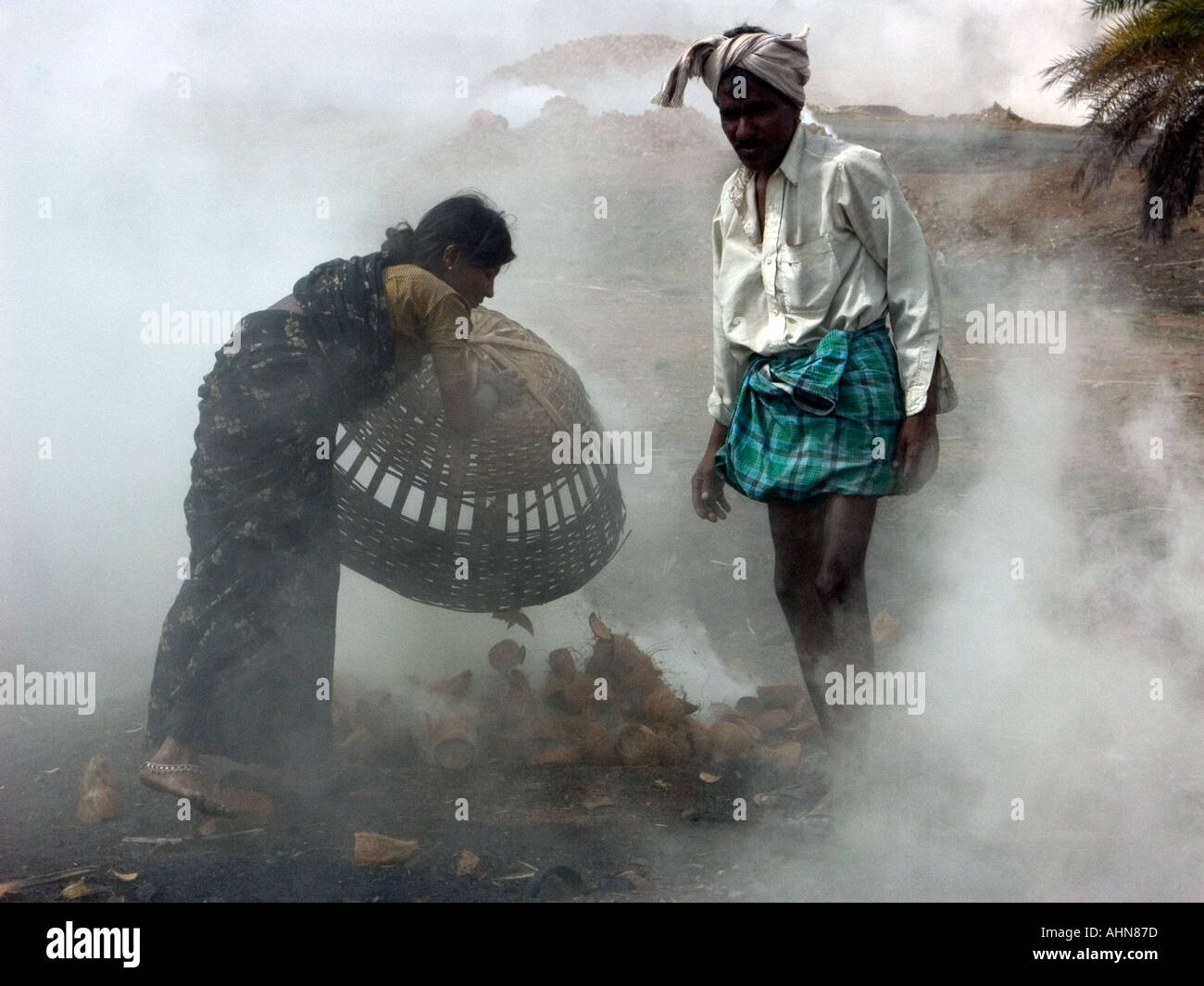 Rural laborers burn coconut husks for fertilizer Stock Photo - Alamy