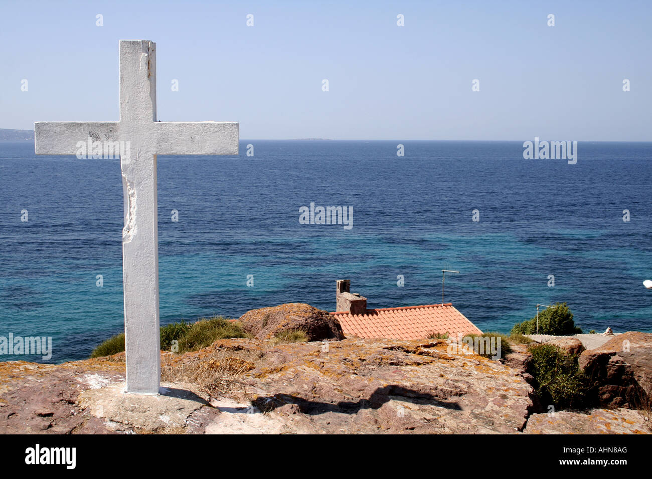 Christian cross overlooking sea at Calasetta, St Antioco, Sardinia ...