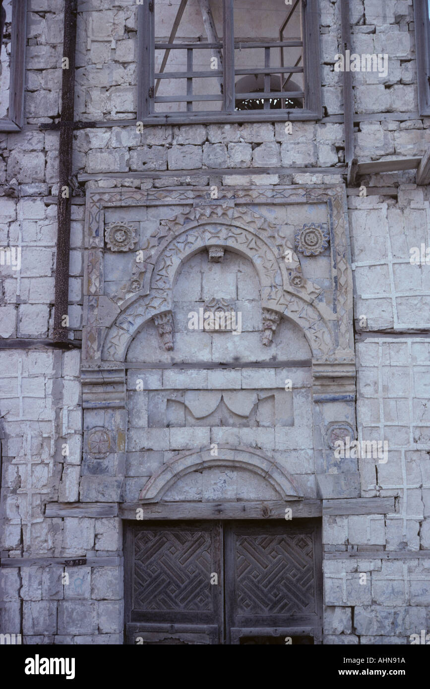Entrance to crumbling ruins of old decorated Turkish house built of ...