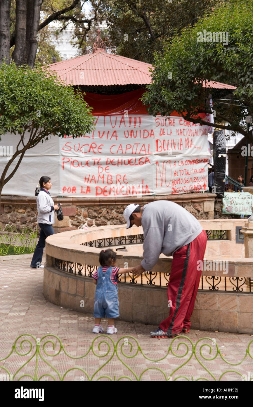 Children playing in front of a hunger strike demonstration in the Plaza ...