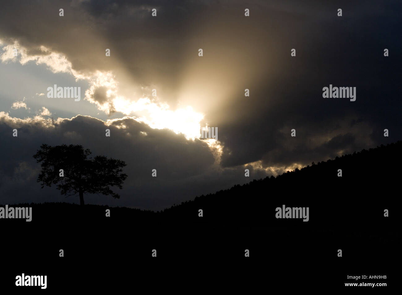 Bright sun rays shining from grey cloud with silver lining Stock Photo ...