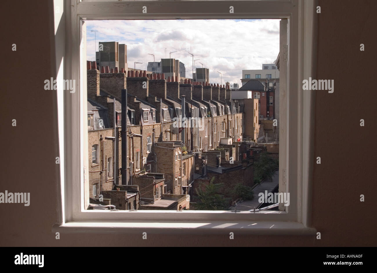View from open window of backs of terraced housing and Brunswick Centre ...