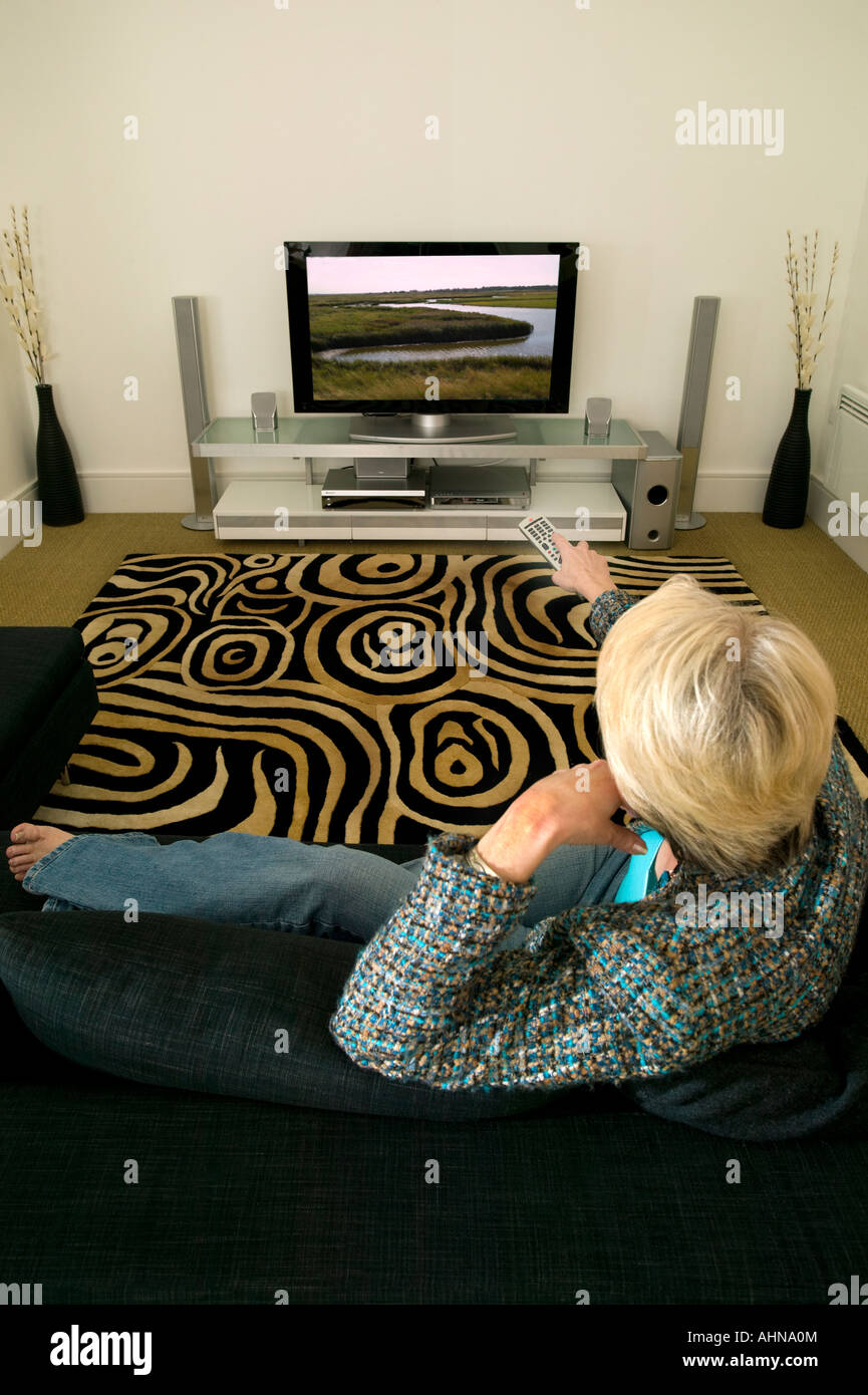woman changing channel on her television Stock Photo - Alamy