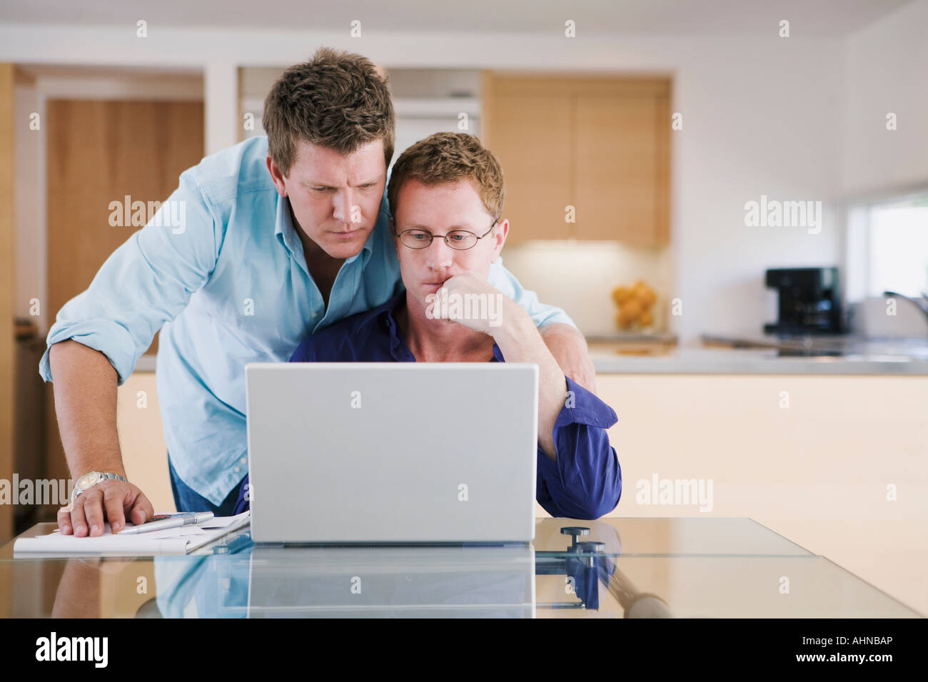 Man watching his boyfriend use a computer Stock Photo - Alamy