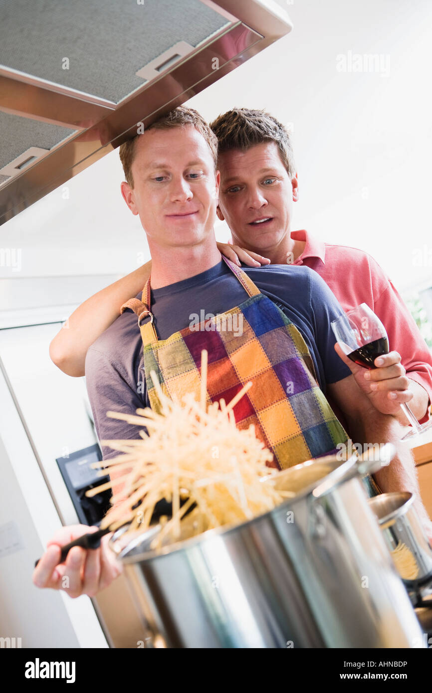 Man stirring pasta in pot of water while cooking Stock Photo - Alamy