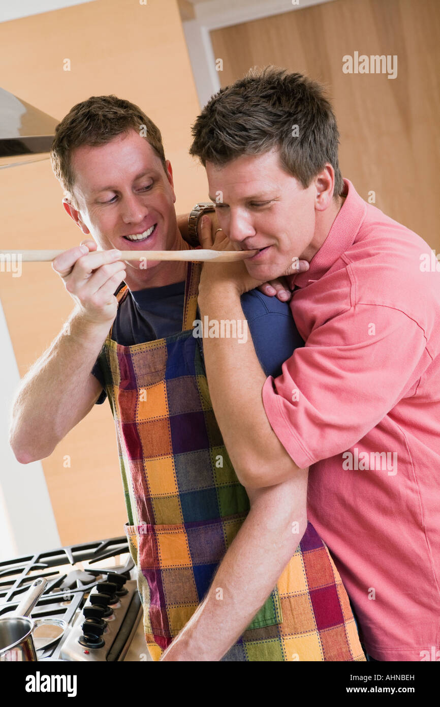 Man tasting his boyfriend’s cooking Stock Photo - Alamy