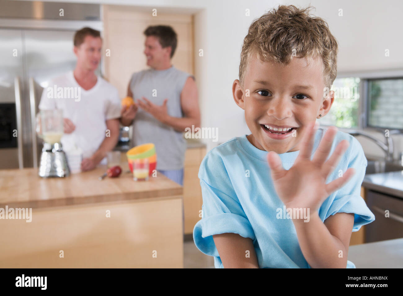 Young boy smiling on kitchen countertop Stock Photo - Alamy