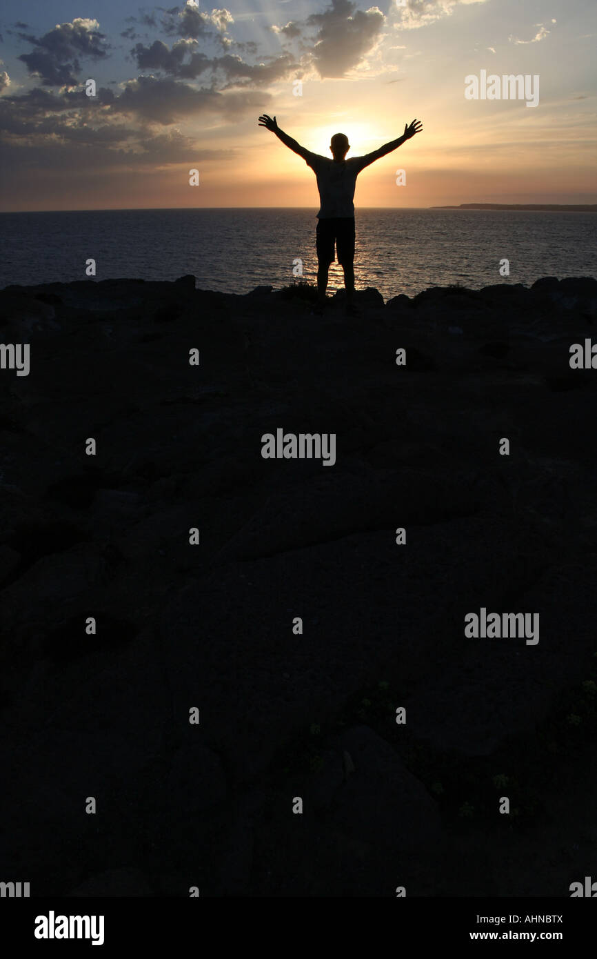 Man with arms aloft and outstretched with sunset in background Taken on ...