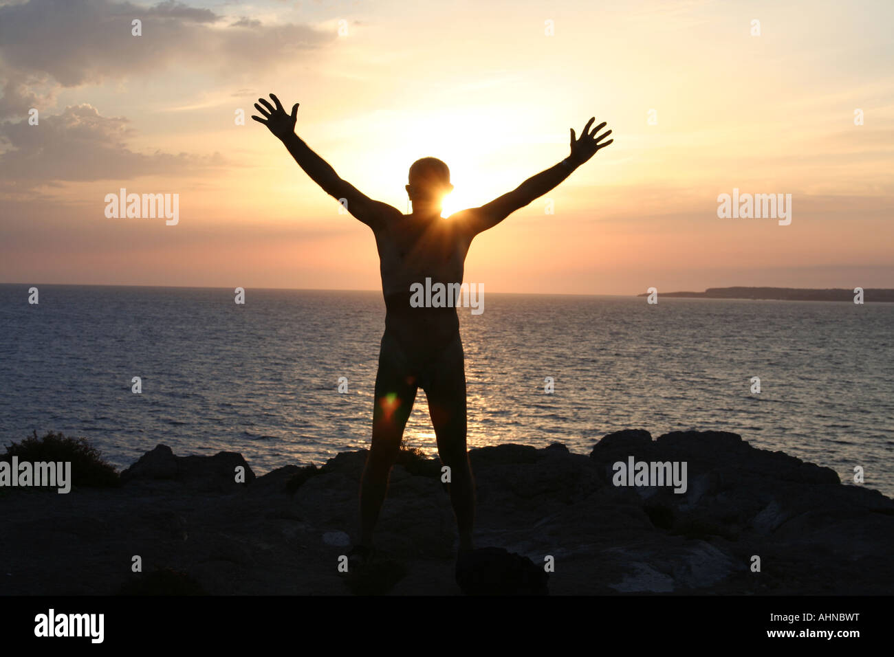 Man with arms aloft and outstretched with sunset in background Taken on ...