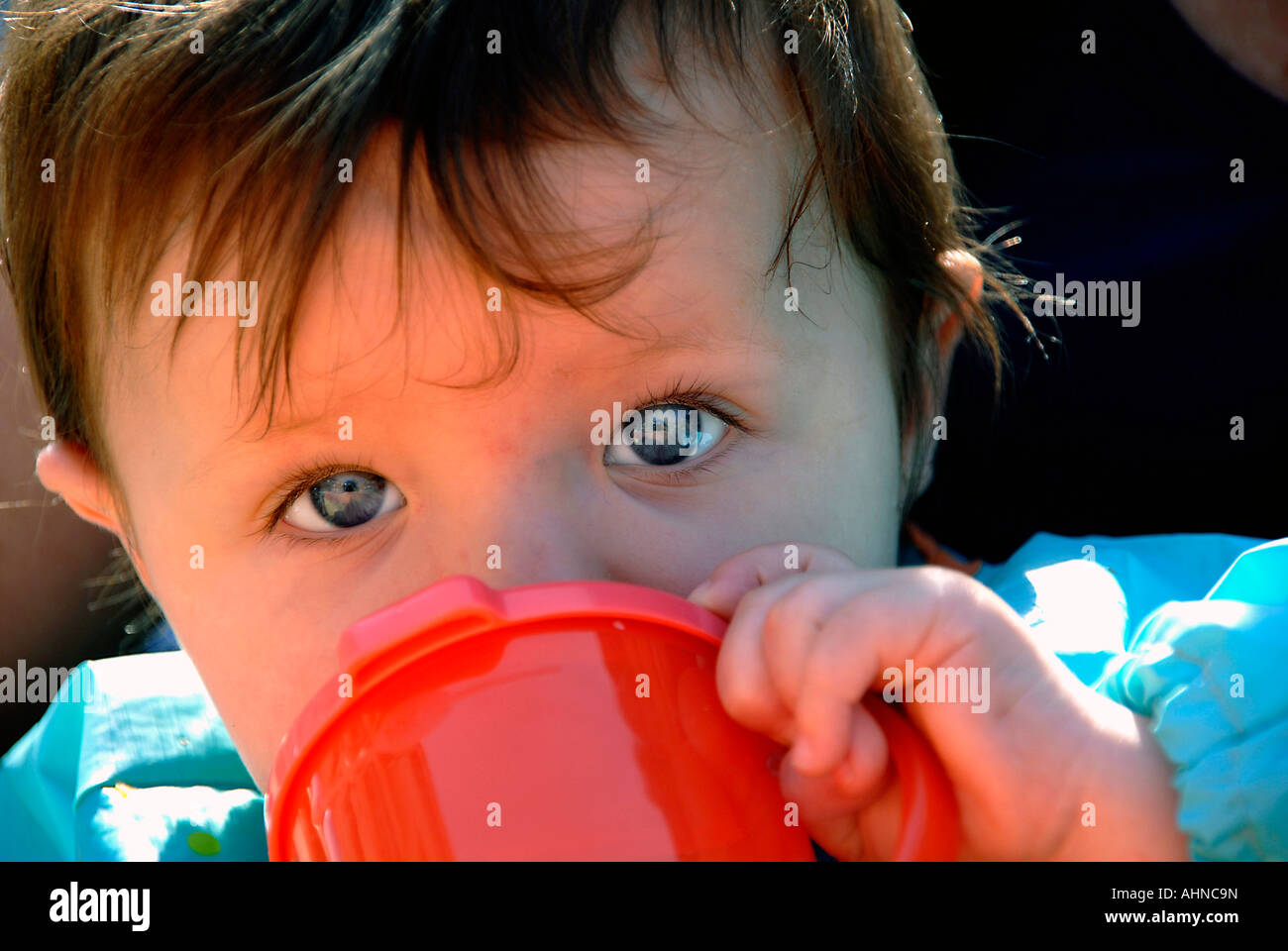 Baby drinking from red cup Stock Photo - Alamy