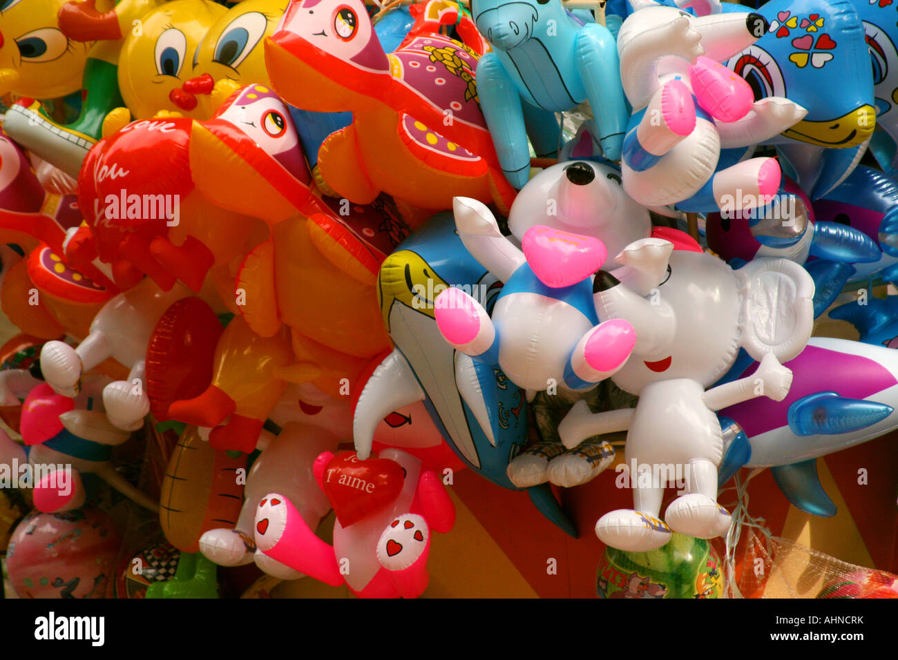 Bright colourful inflatable childrens characters tied together Stock ...