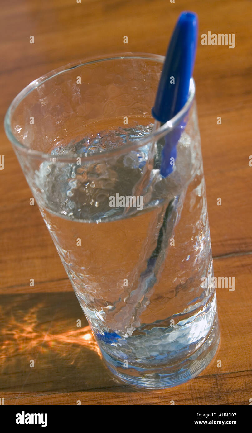 pen in a full water glass Stock Photo - Alamy
