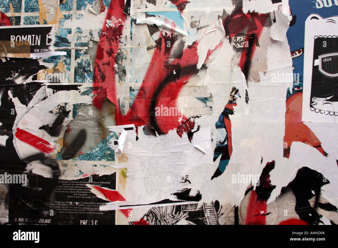 Torn overlapping posters with red and black spray paint graffiti Stock ...