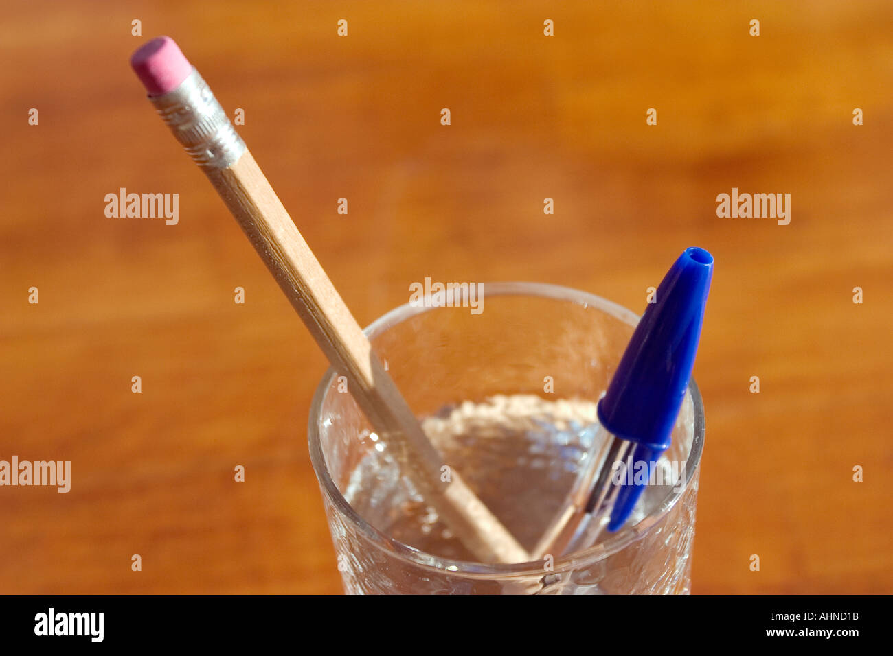pen and crayon in a full water glass Stock Photo - Alamy