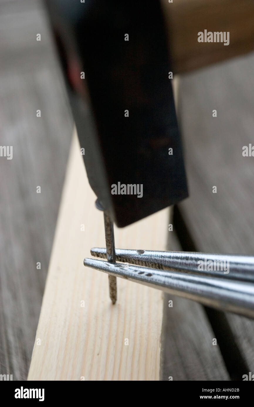Hammer about to strike a nail hi-res stock photography and images - Alamy
