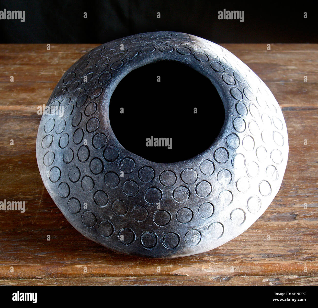 Small smoke fired moulded pot with circle design Stock Photo - Alamy