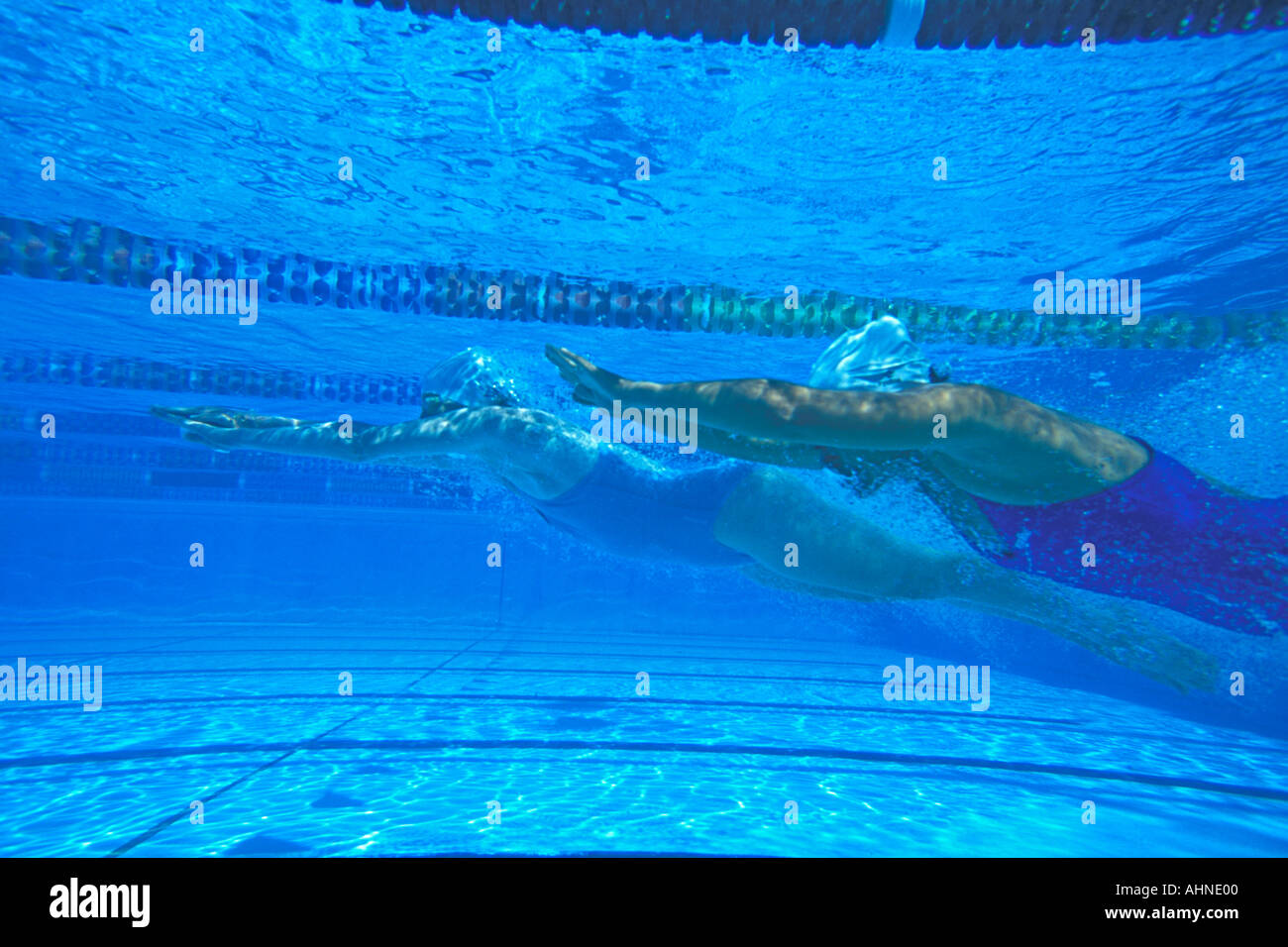 2 women diving into swimming pool Stock Photo - Alamy