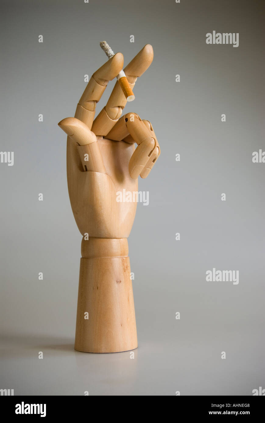 wooden hand with lighted cigarette Stock Photo - Alamy