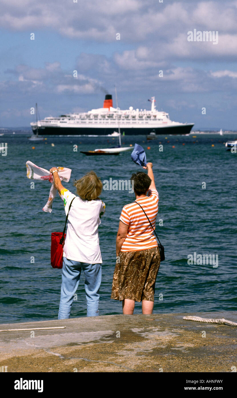 UK Isle of Wight Cowes two women waving off the QE2 Stock Photo - Alamy