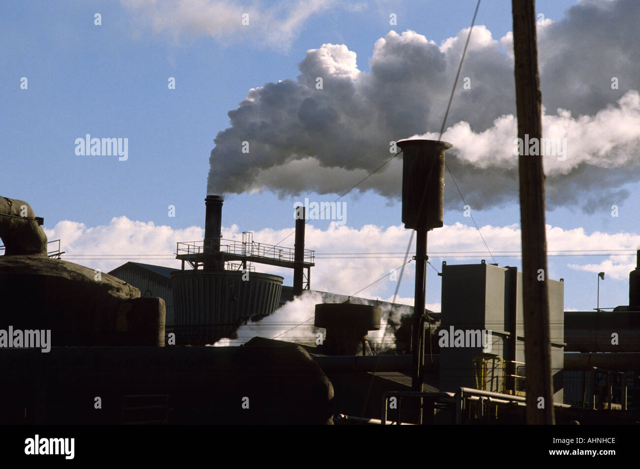 Smoke stacks emit air pollution at a manufacturing plant Stock Photo ...