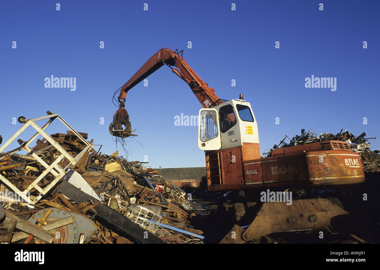 hydraulic crane sorting through scrap metal at waste metal recycling ...