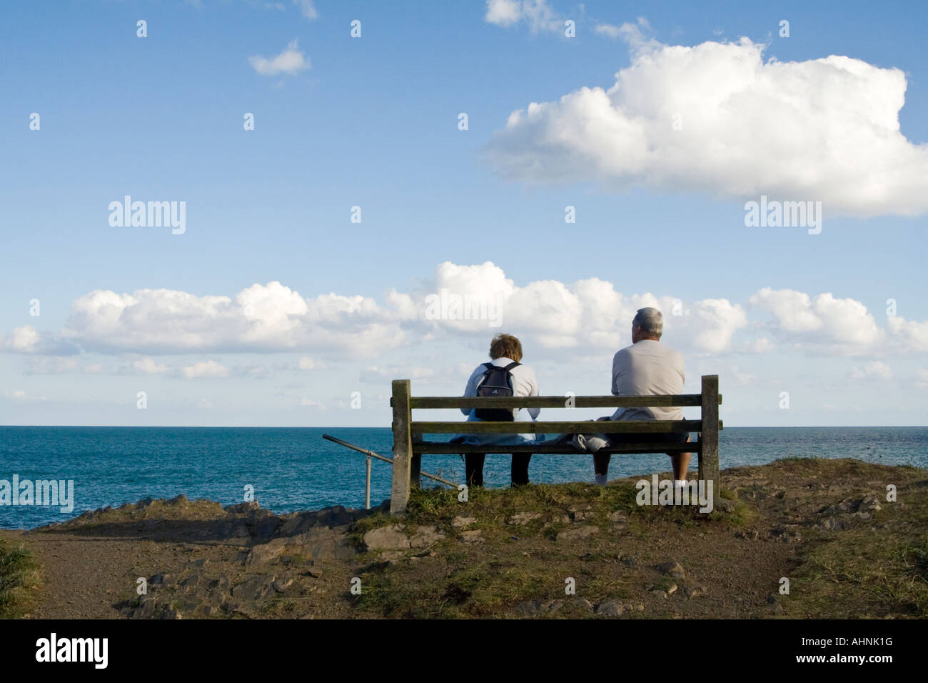 Couple on a seat Stock Photo - Alamy
