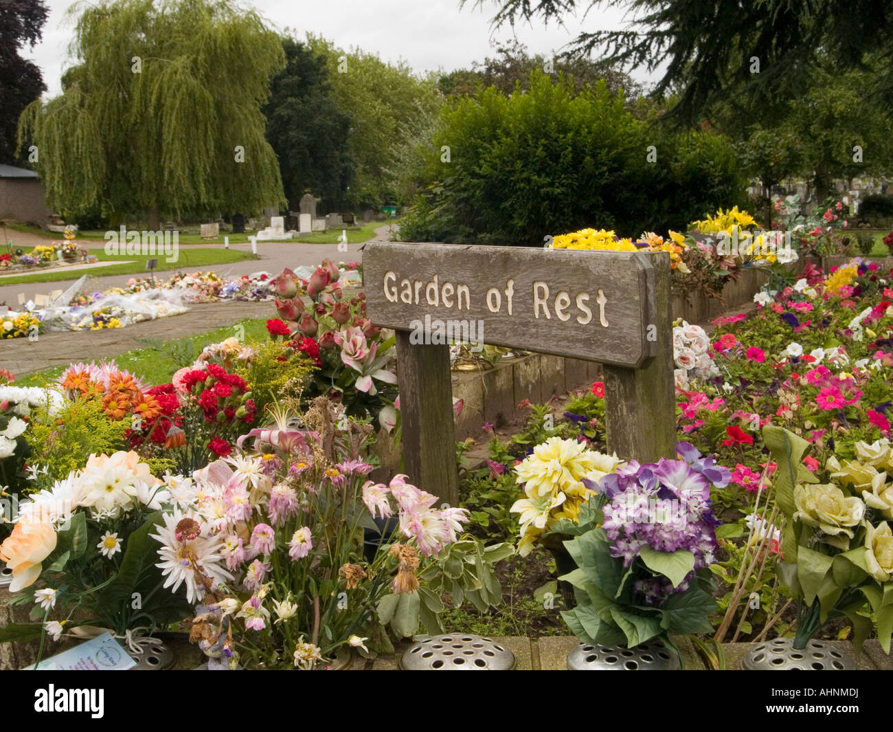 Flowers and floral tributes laid in the Garden of Rest, at a cemetery ...