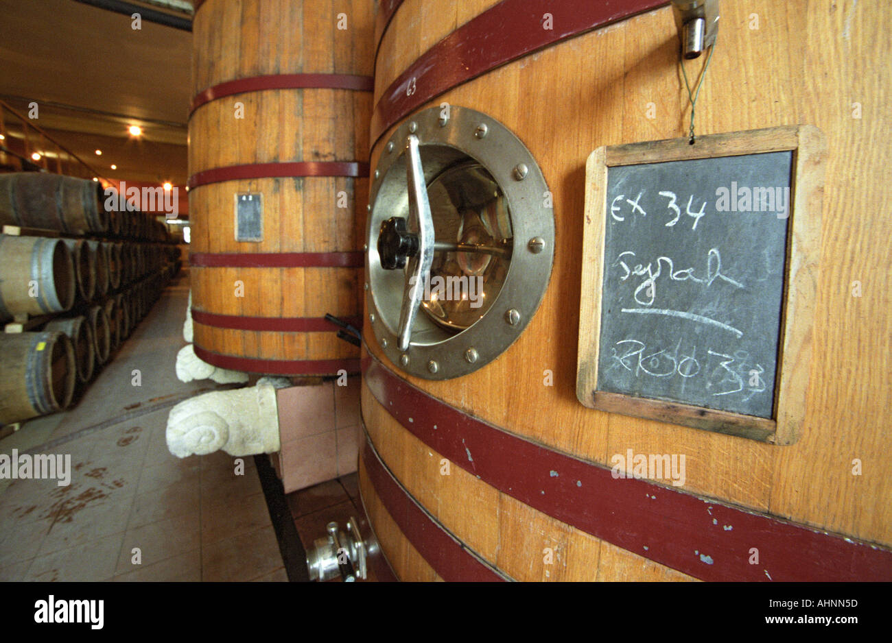 Oak barrels and big foudre fermentation vats in the winery, the plinth ...