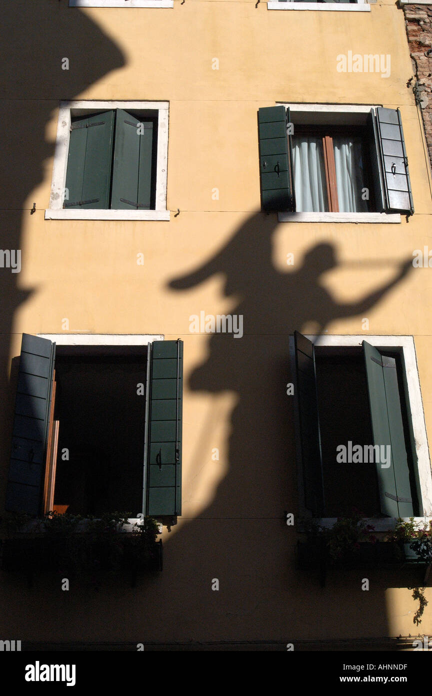 Shadow of angel on building facade Venice Italy Stock Photo - Alamy